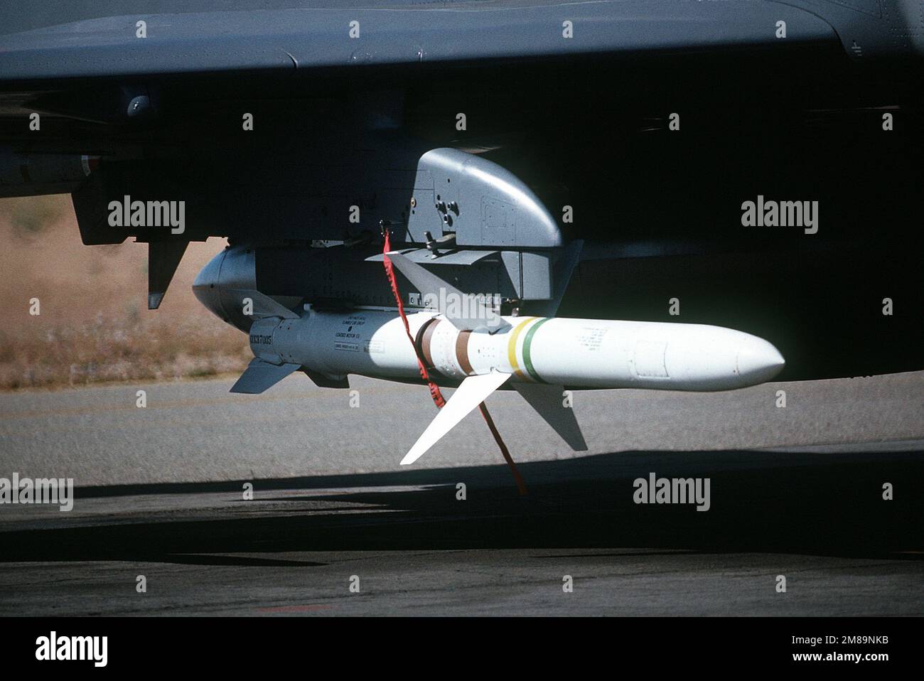 A close-up view of an AGM-45 Shrike missile mounted on the wing pylon ...