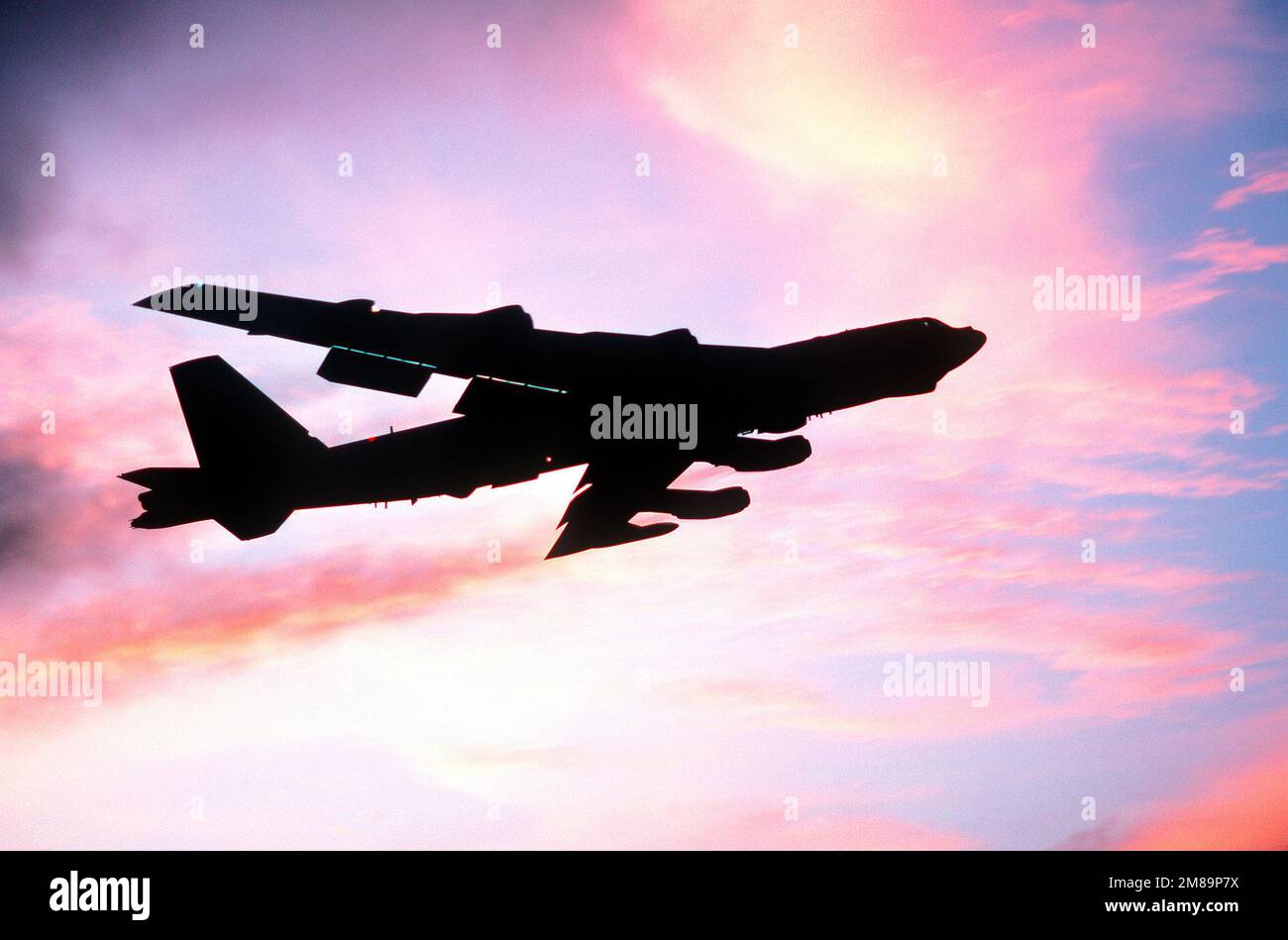 A right underside view of a B-52 Stratofortress aircraft taking off at ...