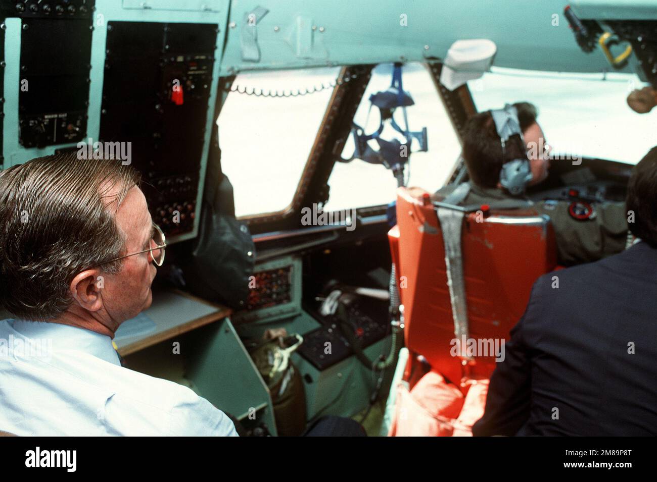 Vice President George Bush observes activities in the cockpit of a 4th ...