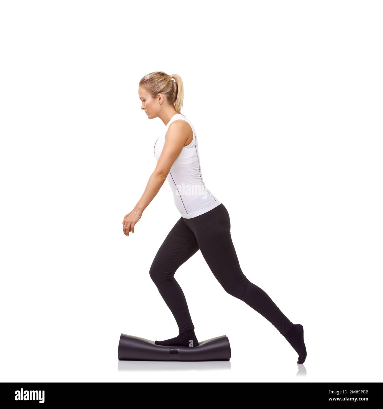 Enjoying her daily exercise routine. A pretty young woman balancing on ...