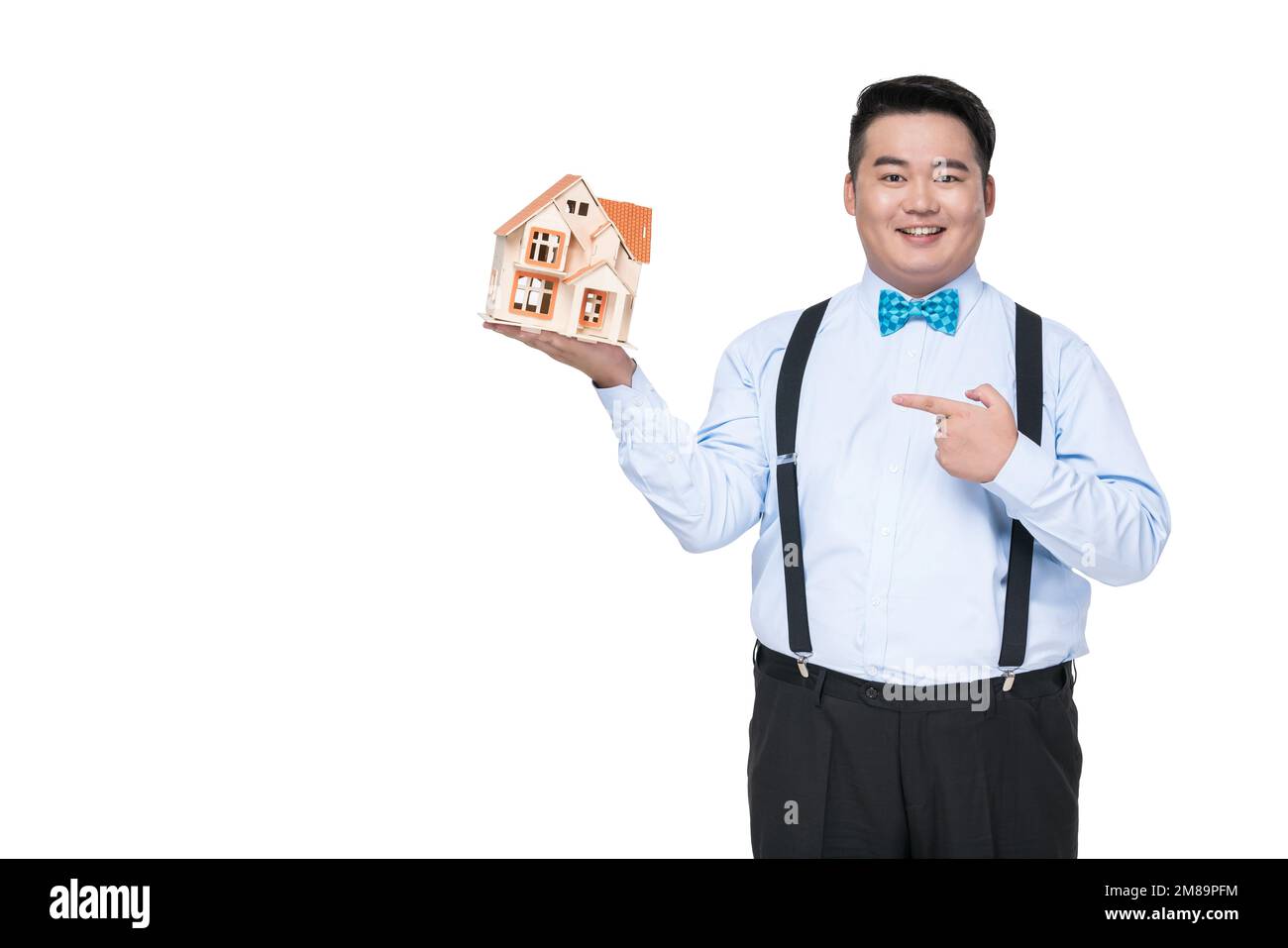 Obese young man with a house model Stock Photo - Alamy
