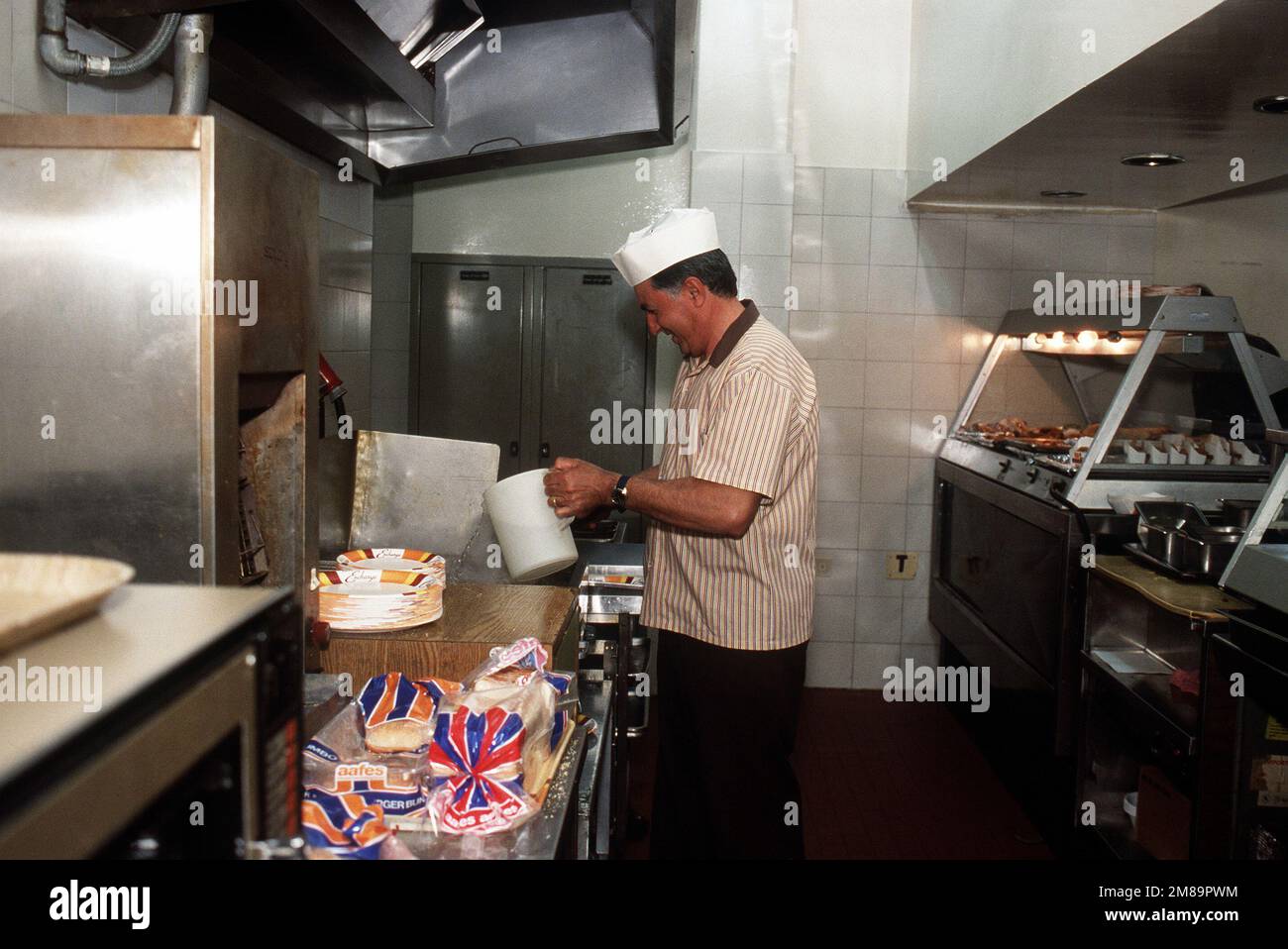 An employee works in the Cat-B Cafeteria, the base's 24-hour coffee ...