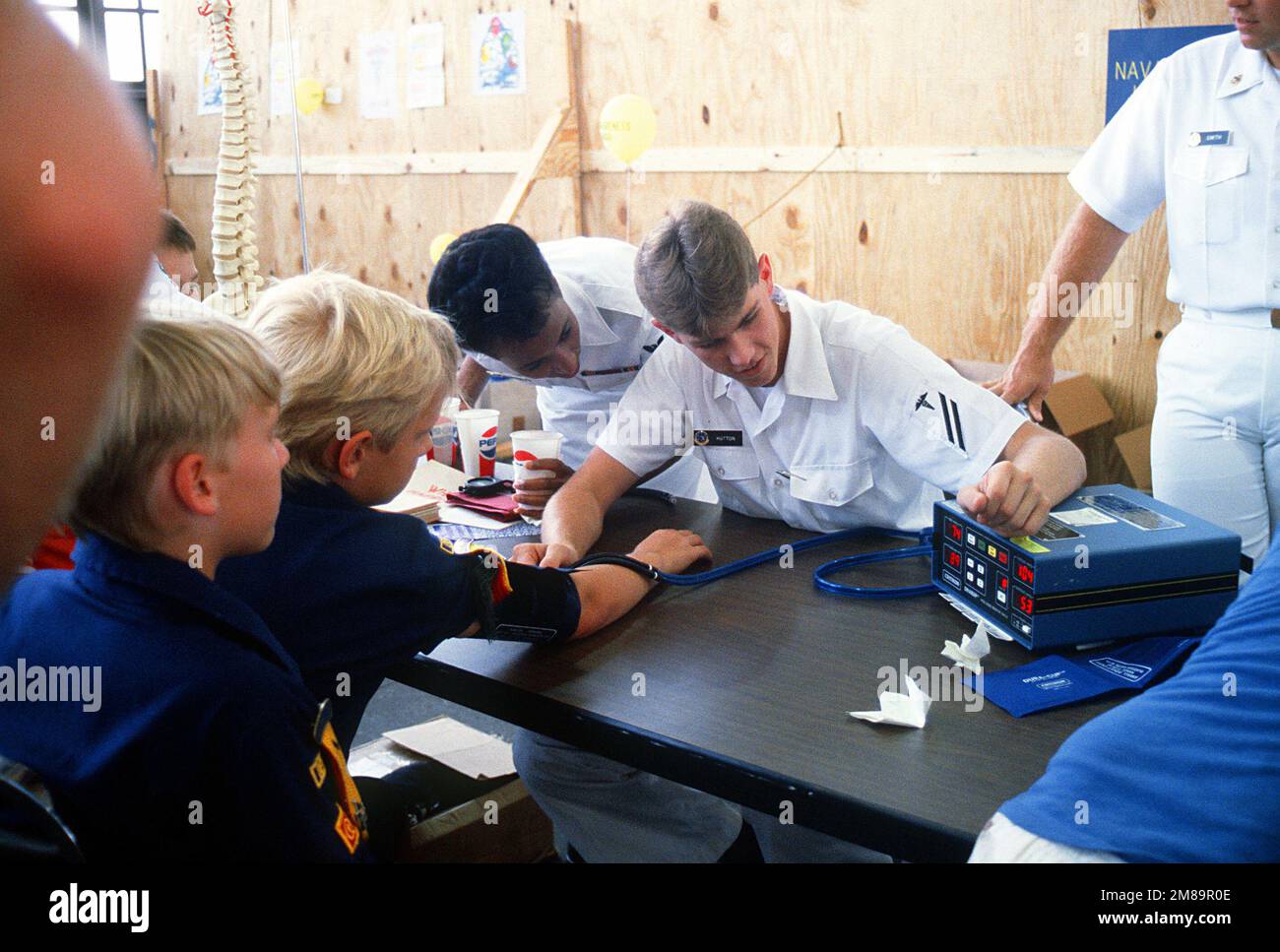 A hospital corpsman seaman apprentice takes the blood pressure of ...