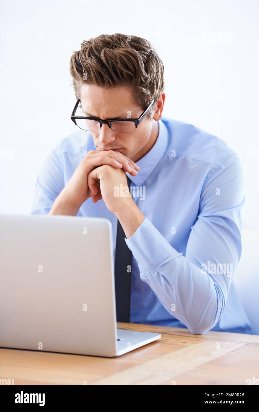 Overcoming project problems. A handsome young businessman focused on ...