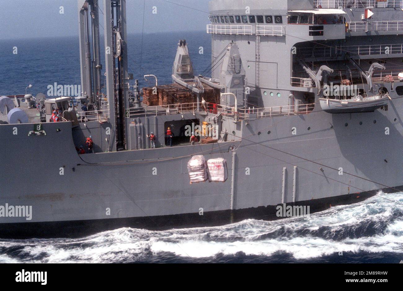 Pallets of cargo are transferred from the combat stores ship USNS SPICA ...