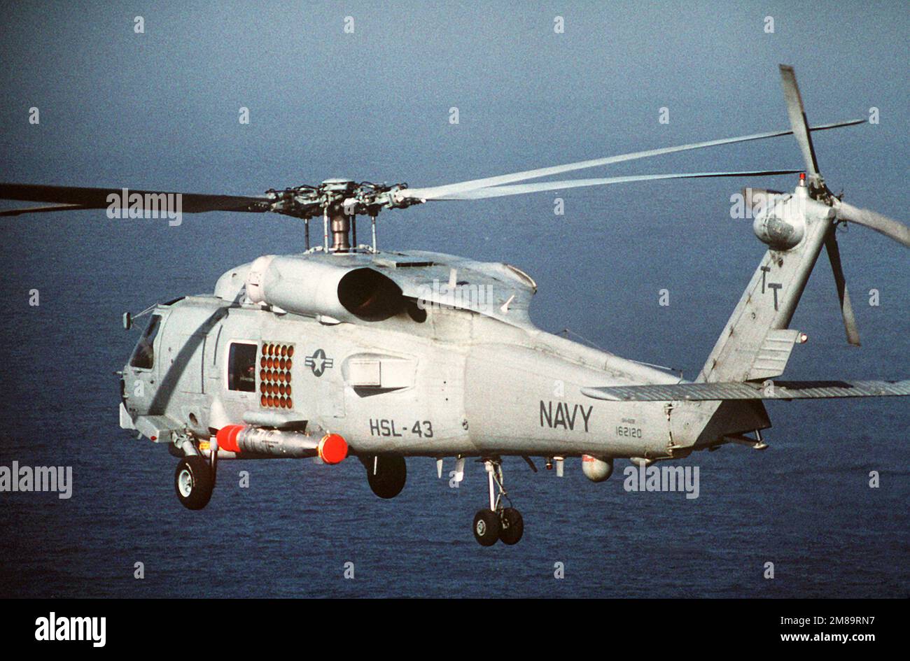 An air-to-air left side view of a Light Helicopter Anti-submarine ...