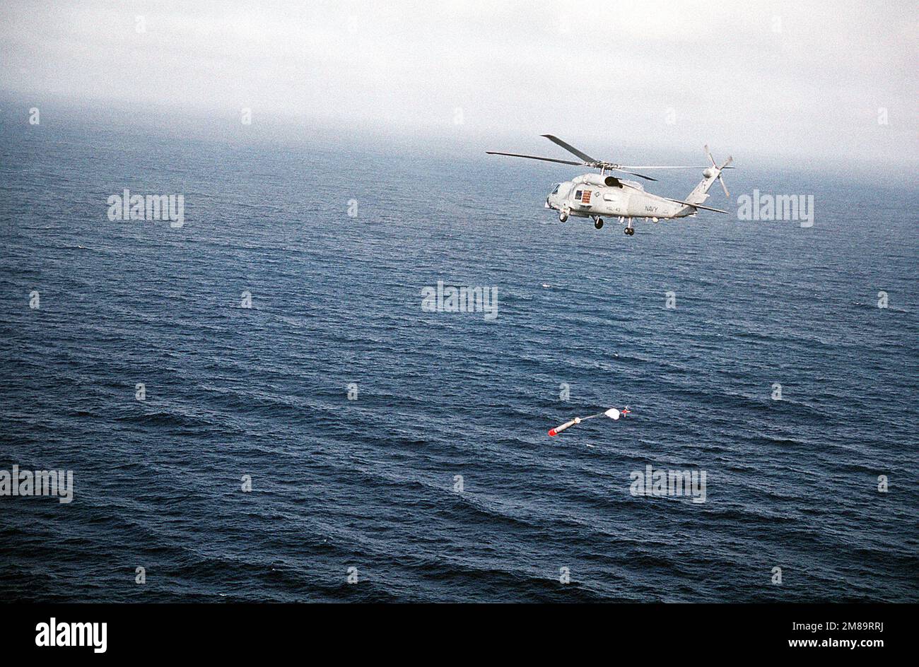An air-to-air left rear view of a Light Helicopter Anti-submarine ...