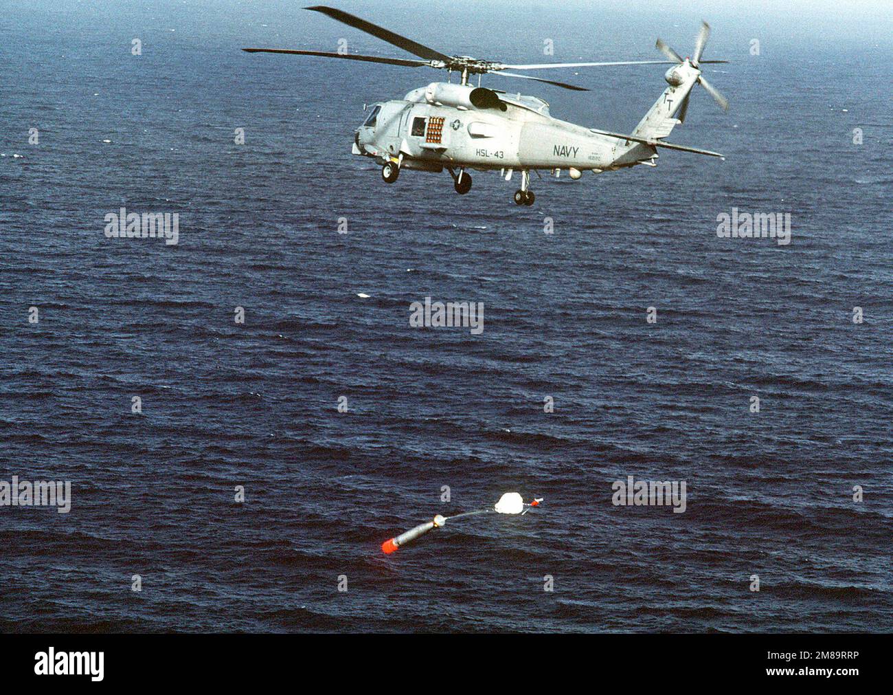 An air-to-air left rear view of a Light Helicopter Anti-submarine ...