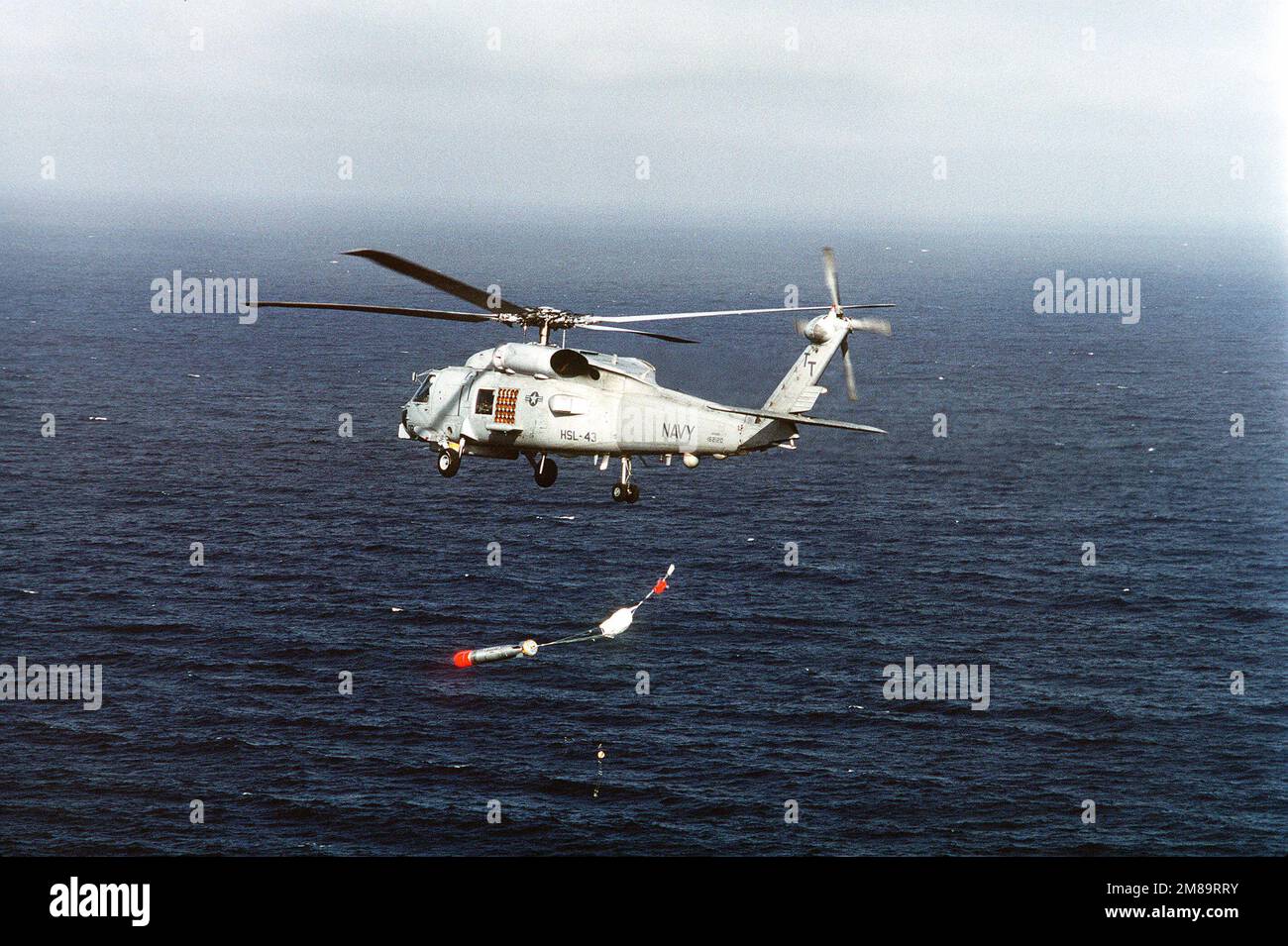 An air-to-air left rear view of a Light Helicopter Anti-submarine ...