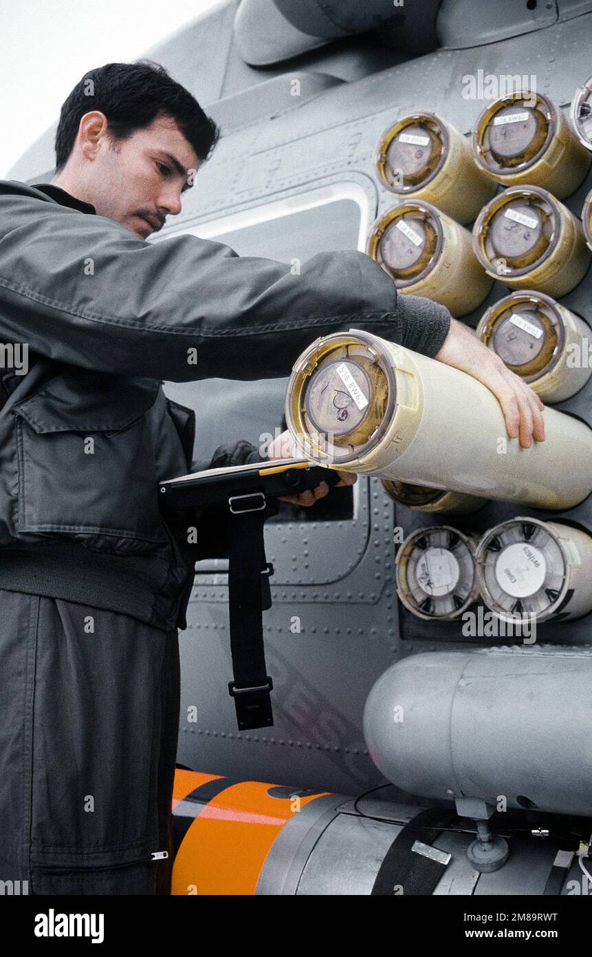 A technician checks sonobuoys installed in the sonobuoy launcher of an ...