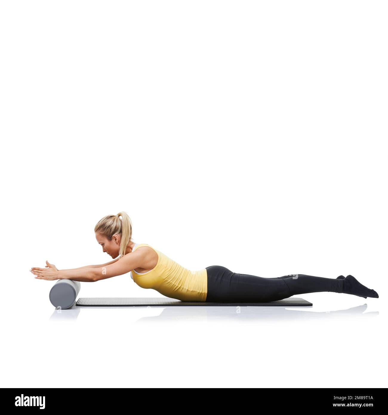 Beautiful blond exercising. A young woman extending her arms and ...