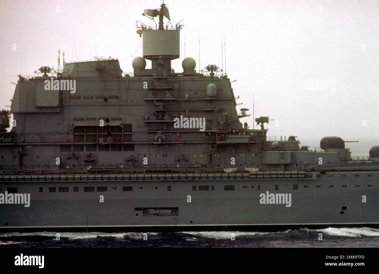 A starboard view of the superstructure, radar equipment, and 100mm gun ...