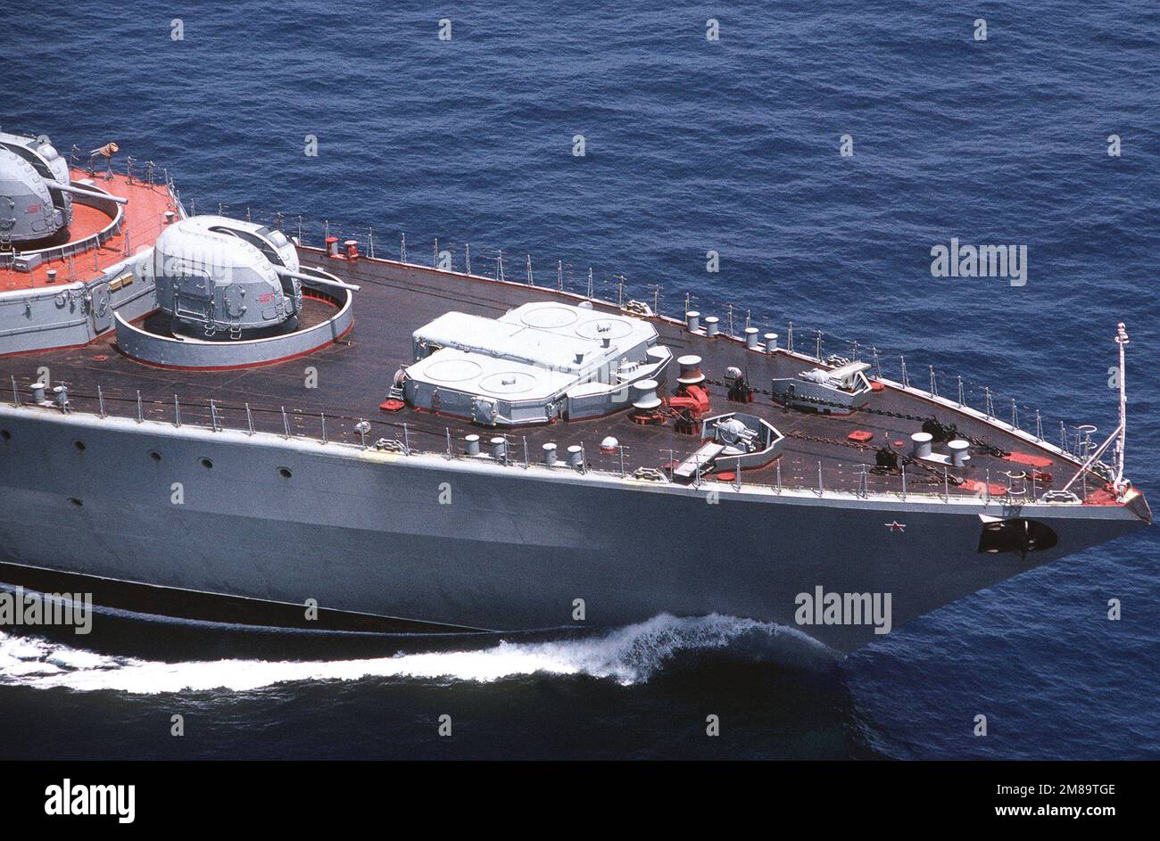 A bow view of 100mm dual purpose guns and a vertical launch system on ...