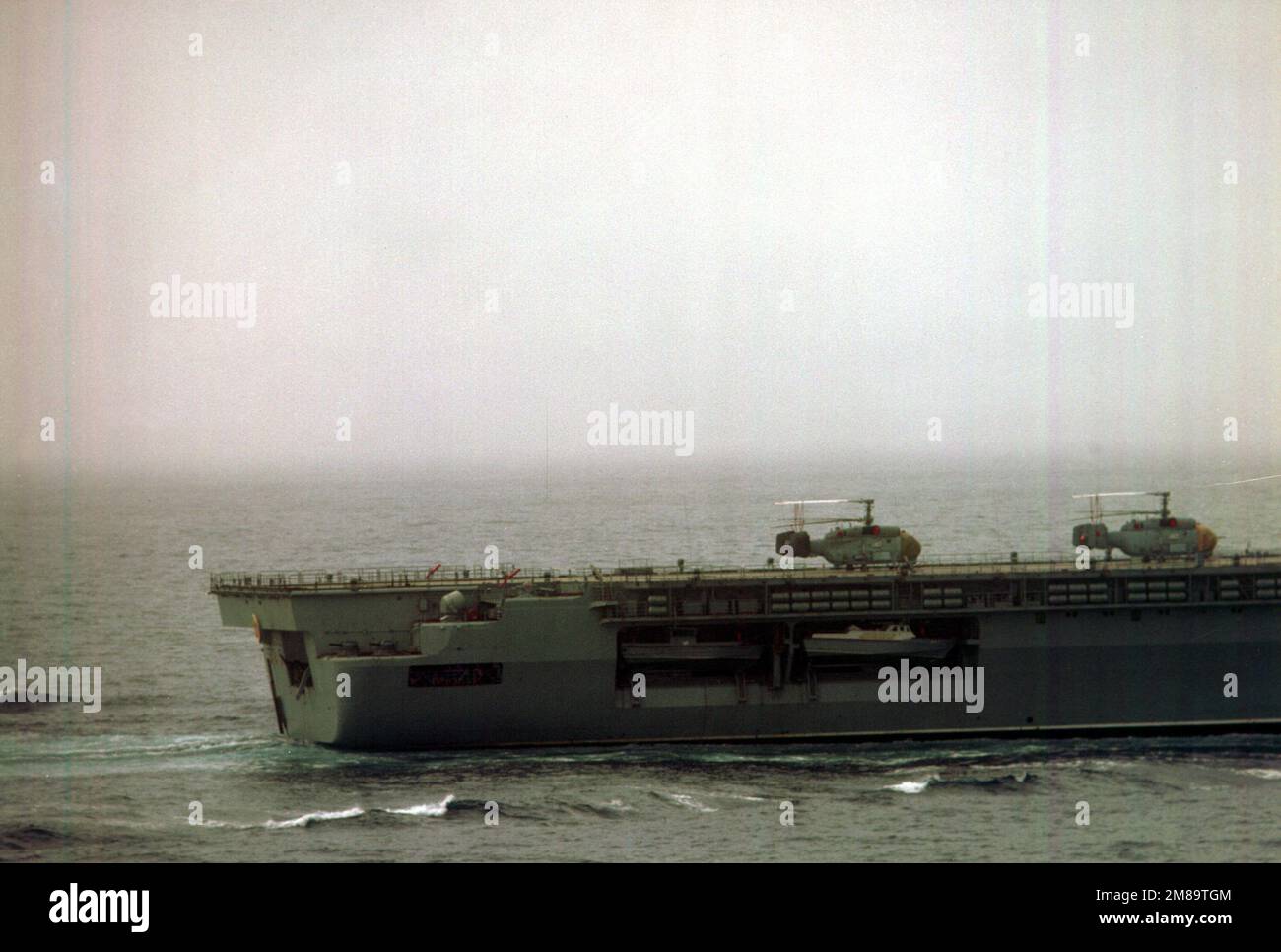 A view of Ka-27 Helix helicopters and covered Yak-36 Forger aircraft on ...