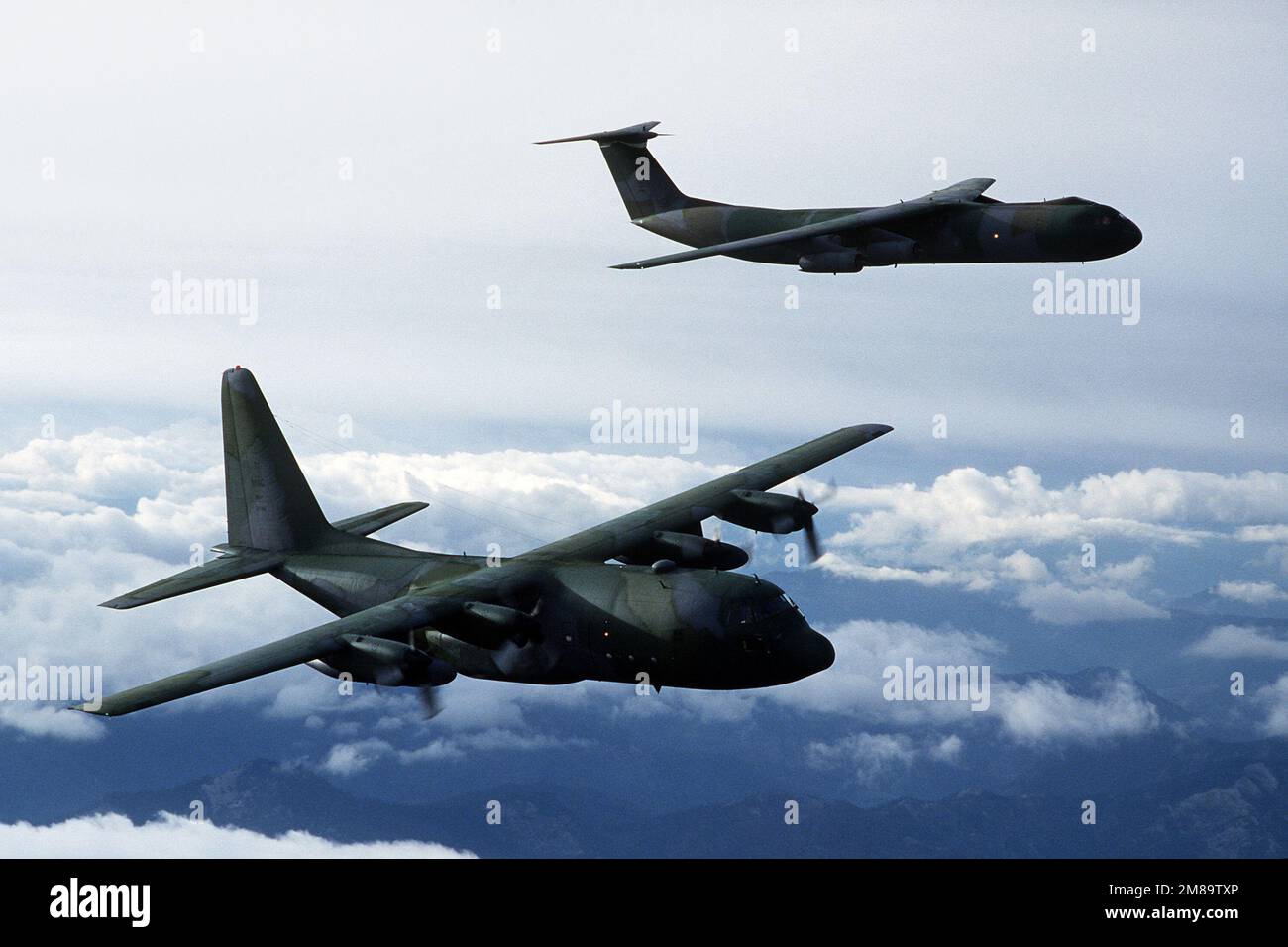 An air-to-air right side view of a C-130E Hercules aircraft of the 36th ...