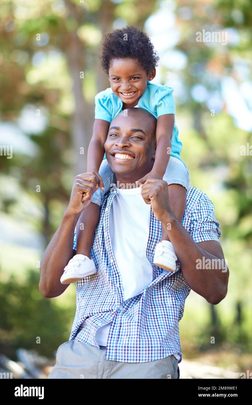 Shes his little princess. A happy young african father spending time with his daughter while ...