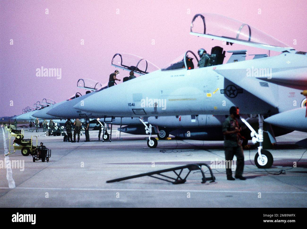 Maintenance personnel work in the early morning hours preparing F-15 ...