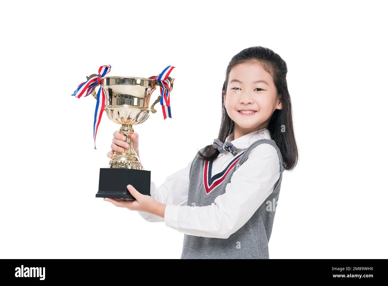 Happy primary school students holding a trophy Stock Photo - Alamy