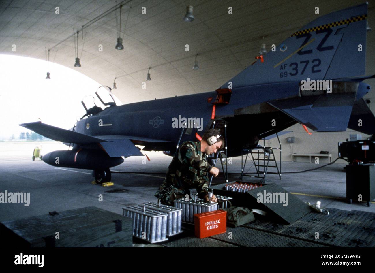 An airman loads flares into a countermeasures dispenser for ...