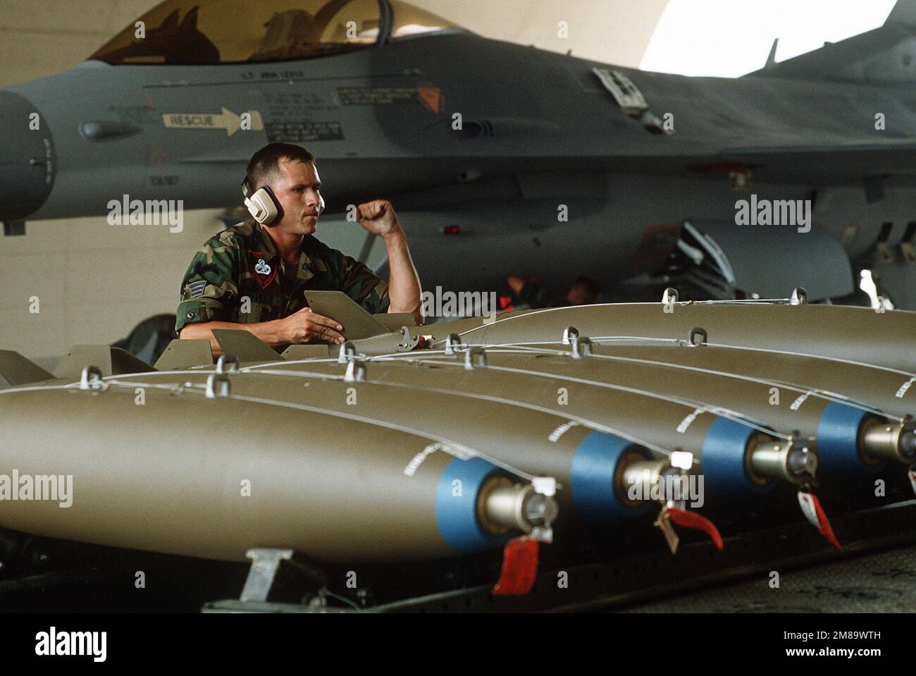 STAFF SGT. Adame Reveile stops a pallet of Mark 82 500-pound bombs as ...