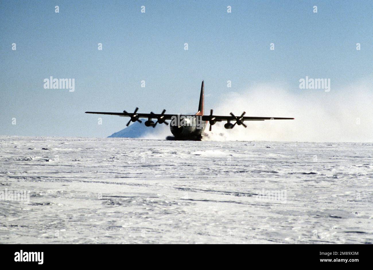 Spreading a wake of blowing snow, a ski-equipped LC-130 Hercules ...