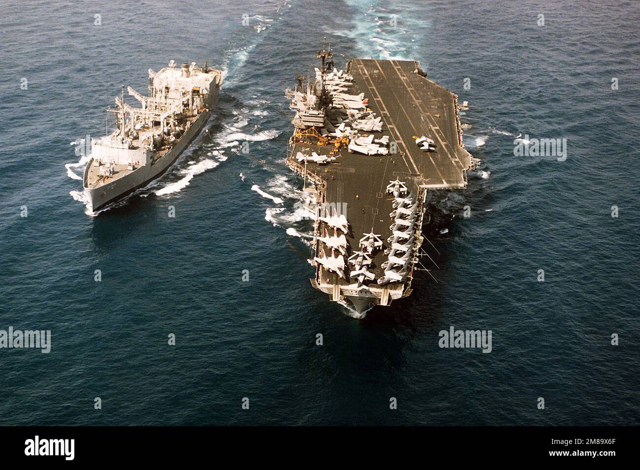 A bow view of the aircraft carrier USS FORRESTAL (CV-59) refueling from ...