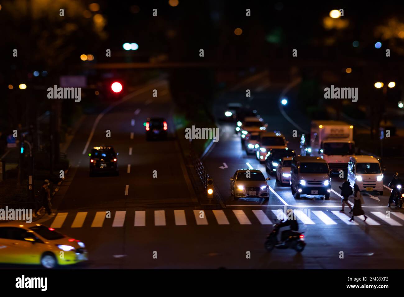 A night timelapse miniature traffic jam at the city crossing in Tokyo ...