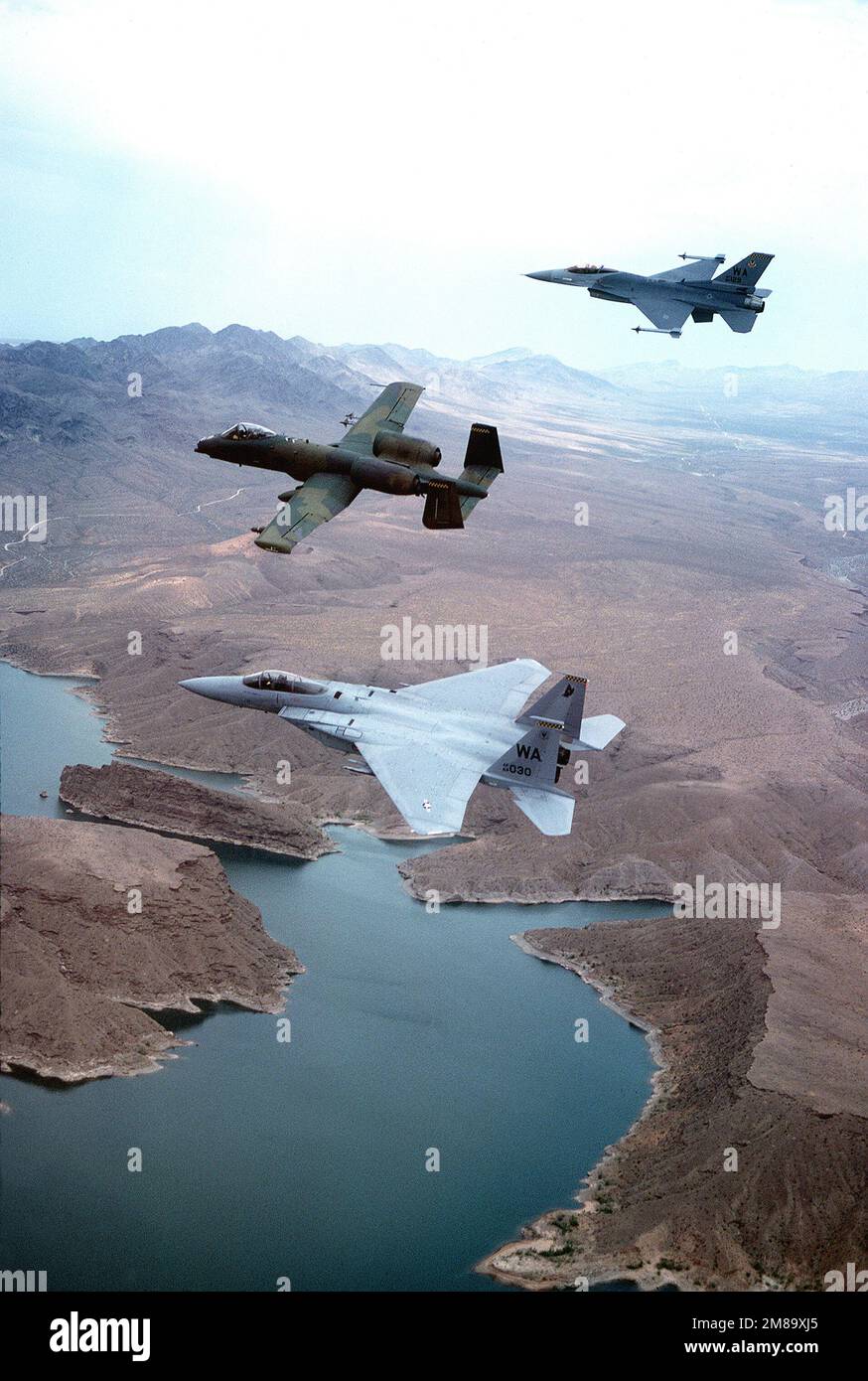 An air-to-air left side view of an F-15C Eagle aircraft, an A-10A ...