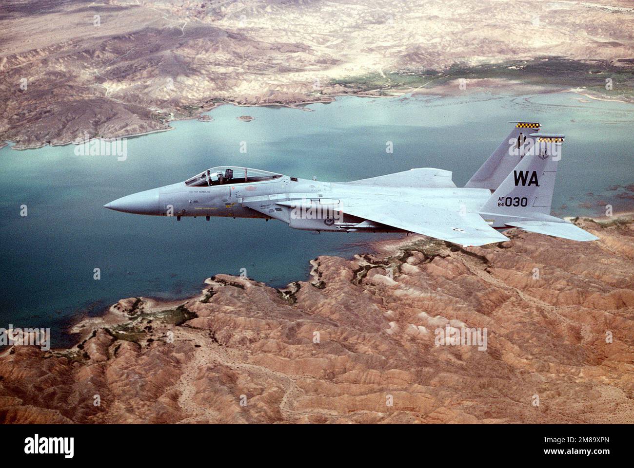 An air-to-air left side view of an F-15C Eagle aircraft from the 422nd ...