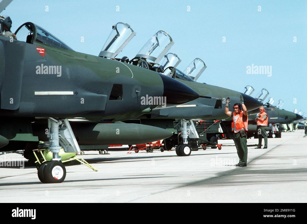 A USAF male crew chief tightens a screw on the air speed indicator of ...