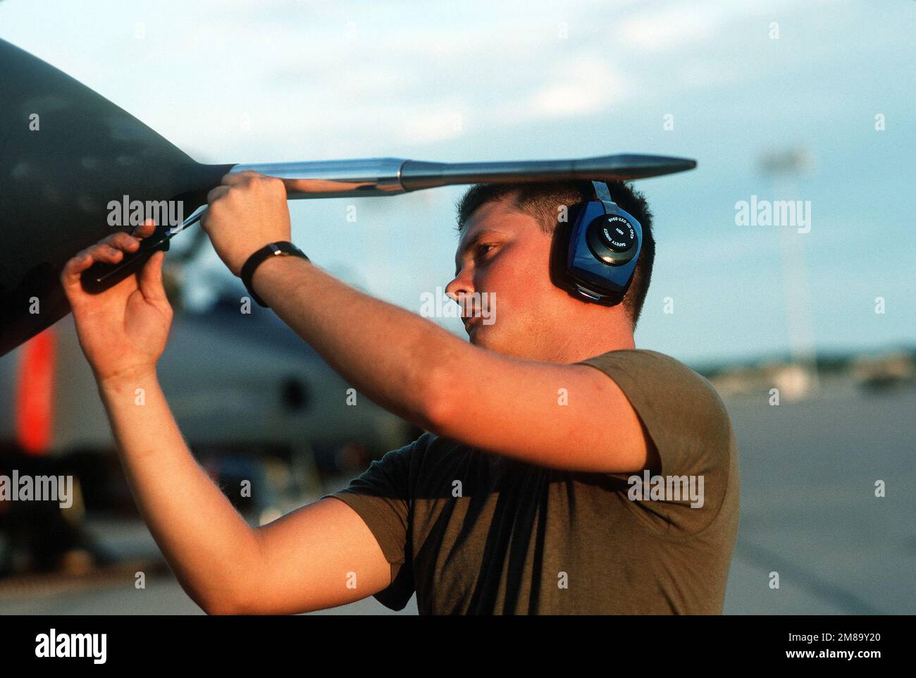 A USAF crew chief places protective cover on the air speed indicator of ...