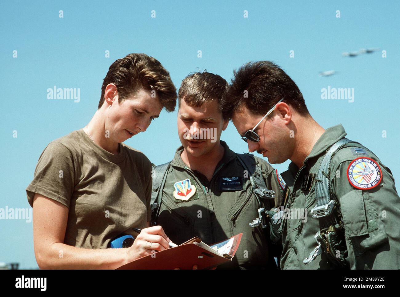 A USAF female crew chief goes over the RF-4C Phantom aircraft forms ...