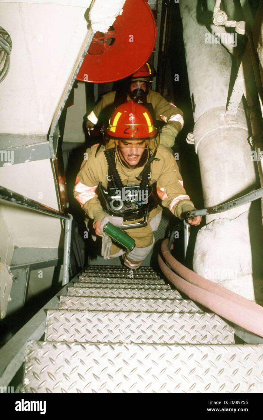 Firefighters take part in a damage control drill aboard the battleship ...