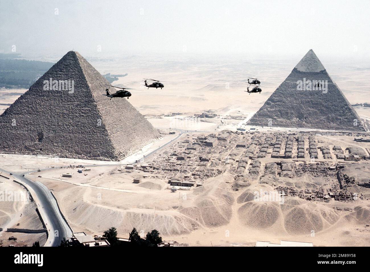 Five U.S. Army UH-60 Black Hawk (Blackhawk) helicopters fly over the ...