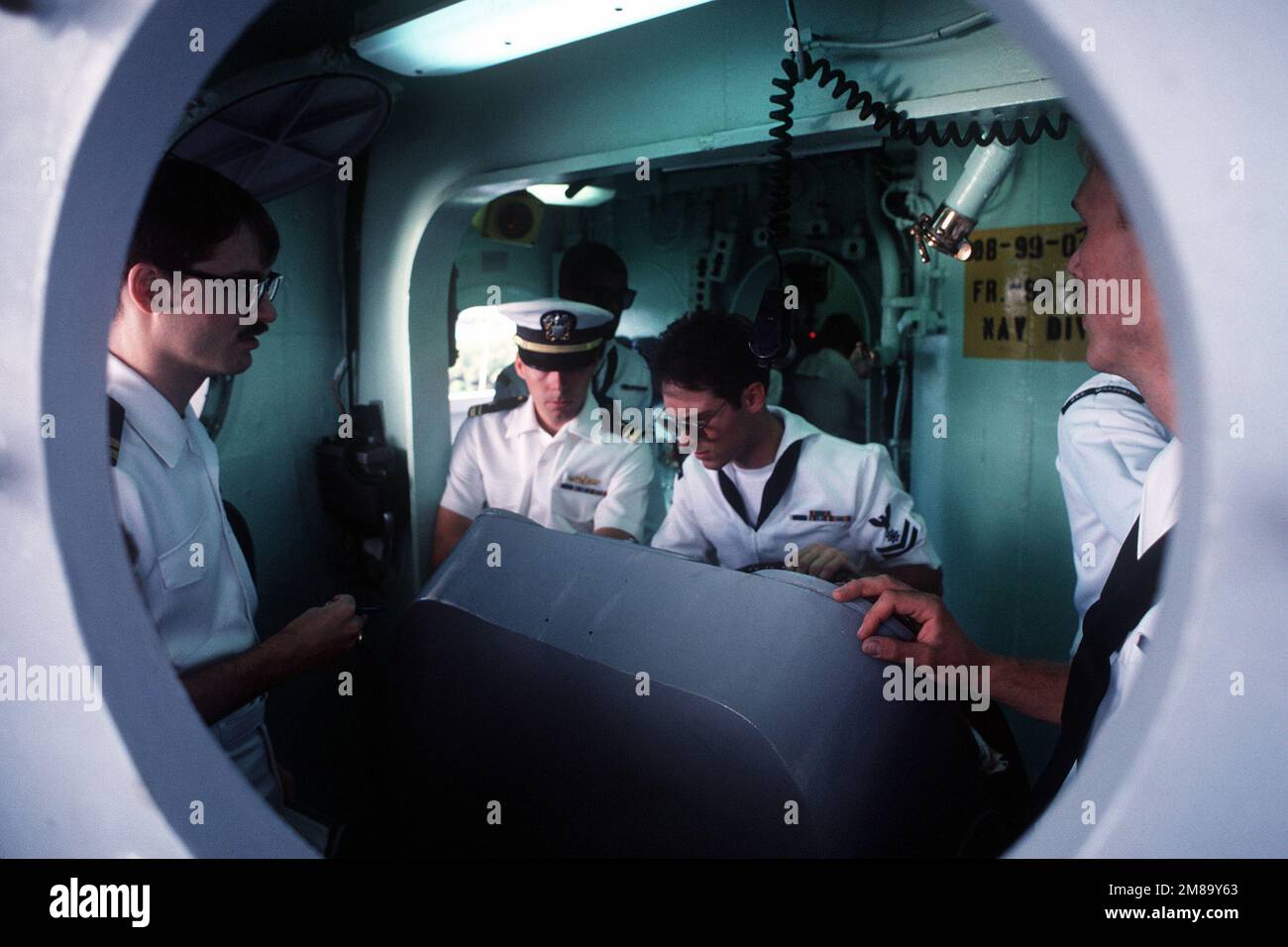 The helmsman mans the wheel of the battleship USS MISSOURI (BB-63 ...