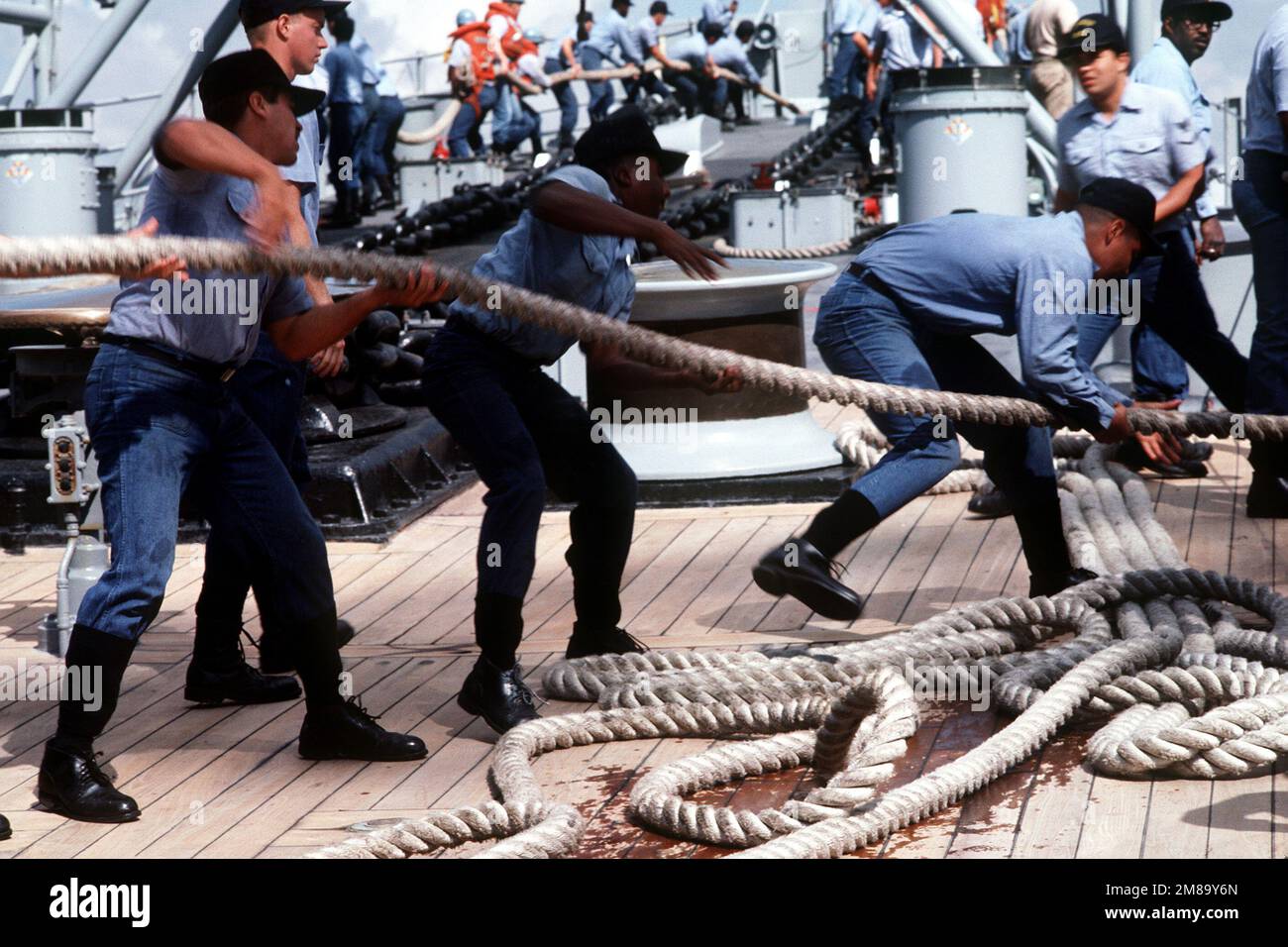 Crew members aboard the battleship USS MISSOURI (BB-63) handle the ...