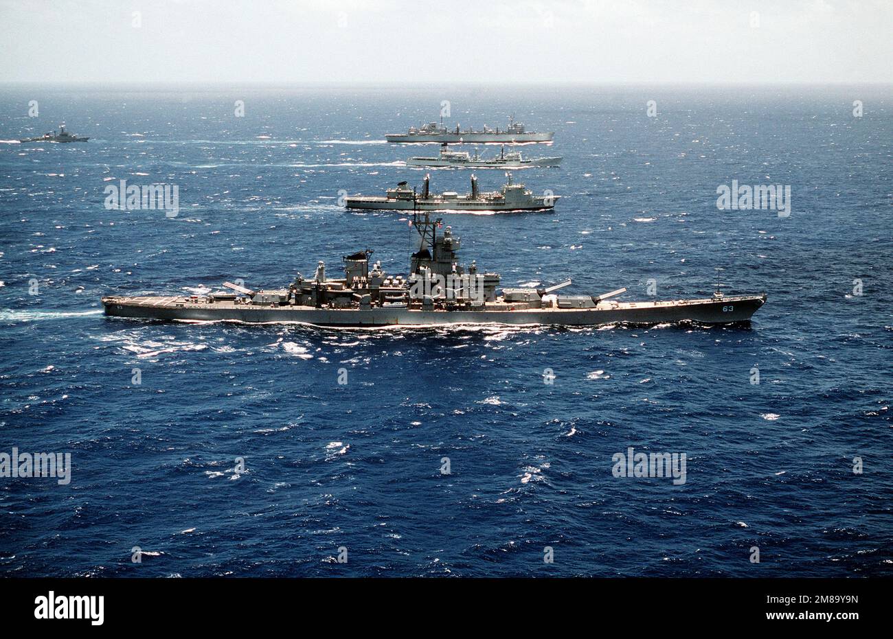 A starboard beam view of, from forefront: the battleship USS MISSOURI ...