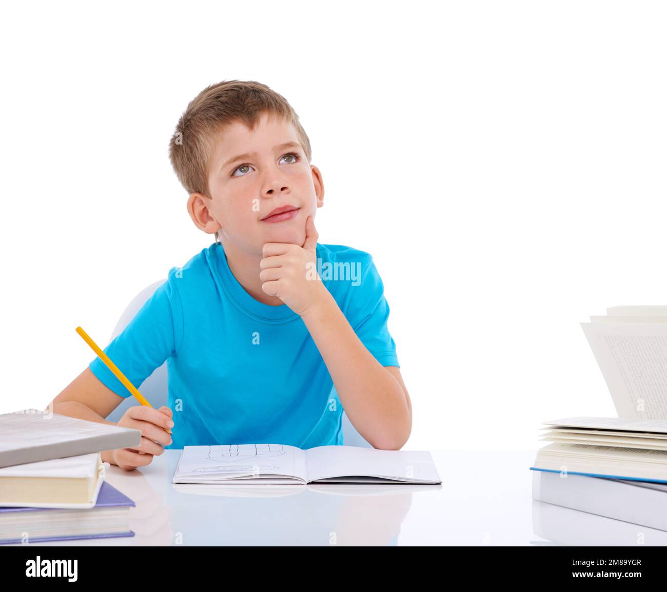 Young boy, writing and thinking with books at desk for school ...