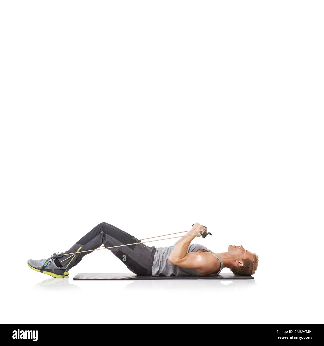 Getting ripped. A young man working out with a resistance band Stock ...