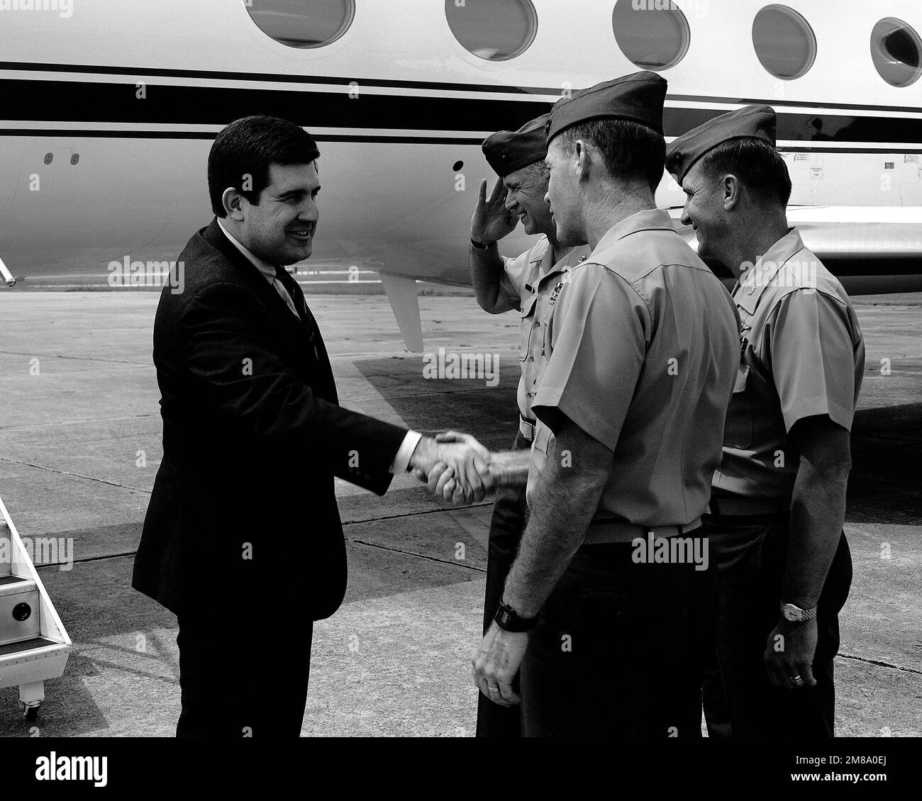 Upon his arrival for an official visit, Secretary of the Navy William L. Ball III is greeted by ...