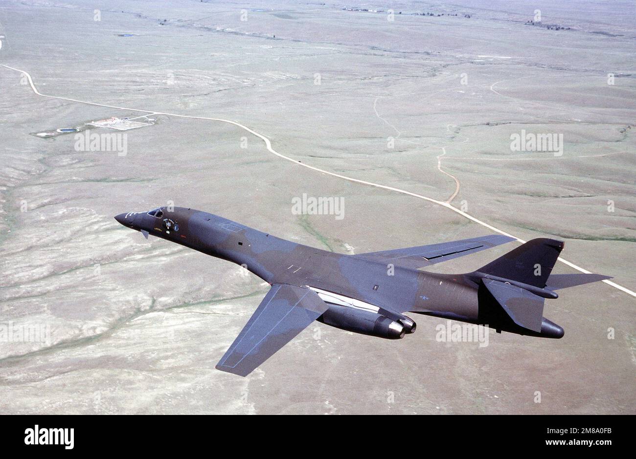 An air-to-air left side view of a 28th Bombardment Wing B-1B aircraft ...