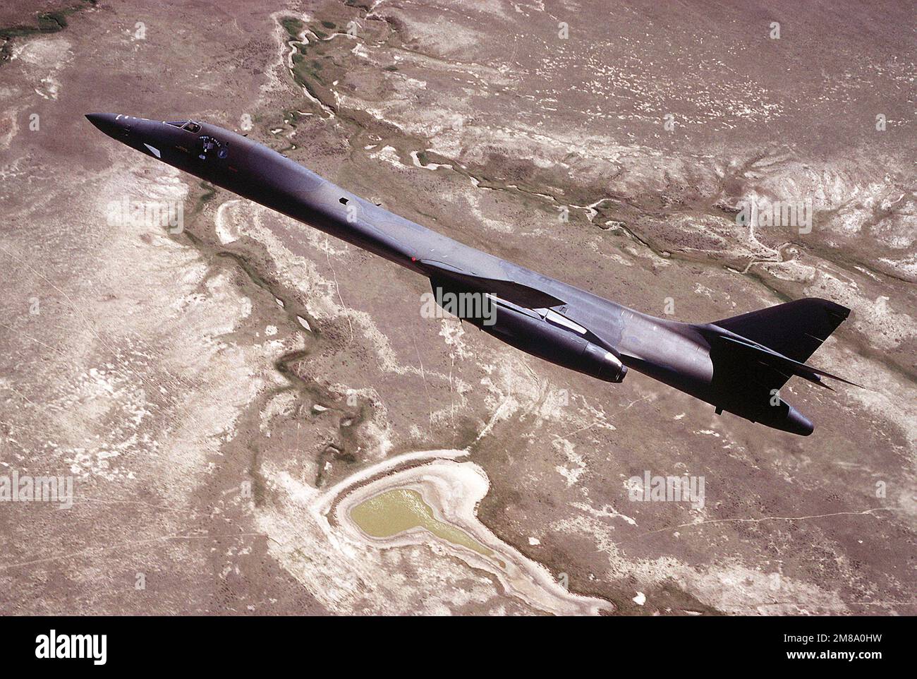 An air-to-air left side view of a 28th Bombardment Wing B-1B aircraft ...