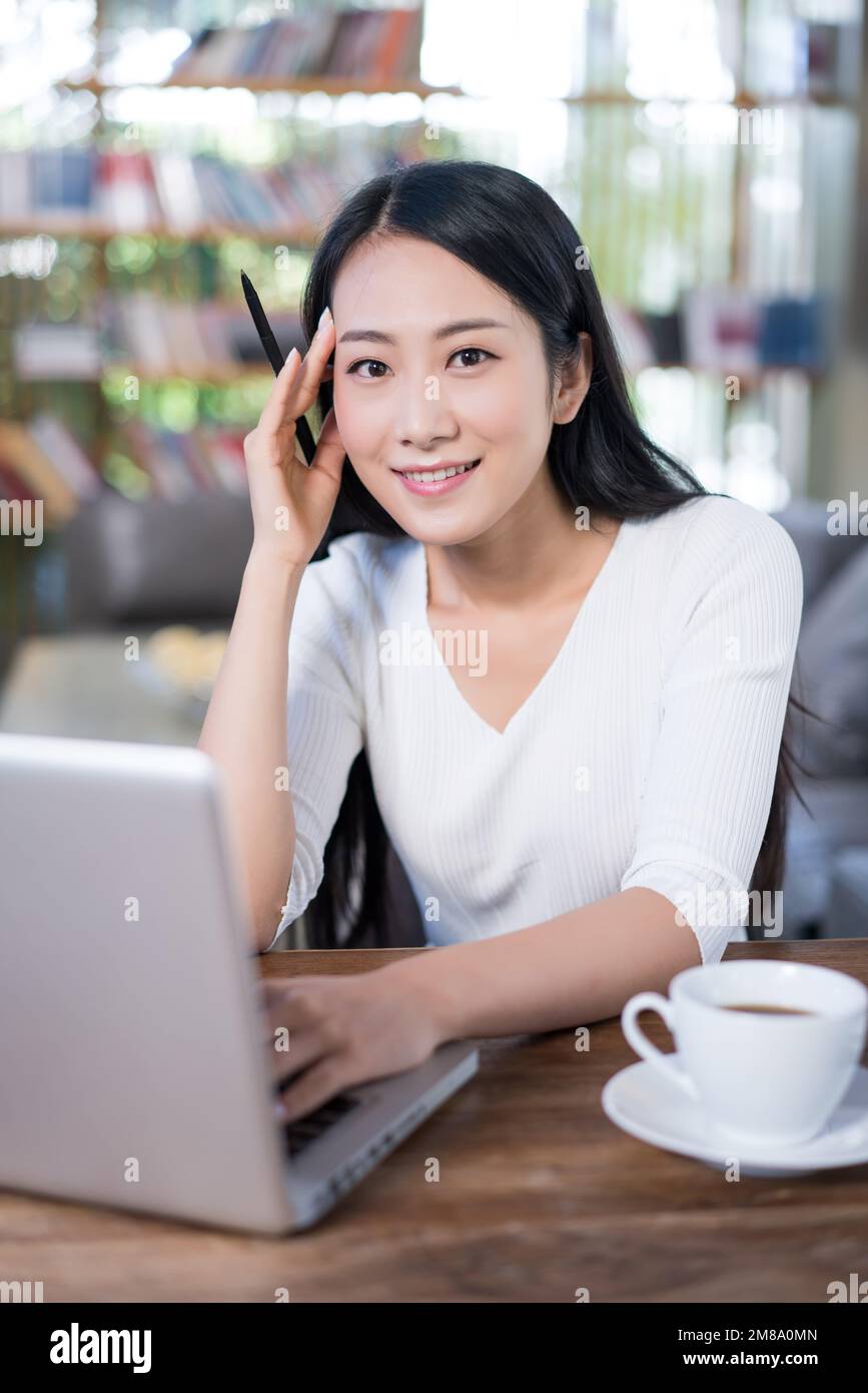 A young woman use the computer Stock Photo - Alamy