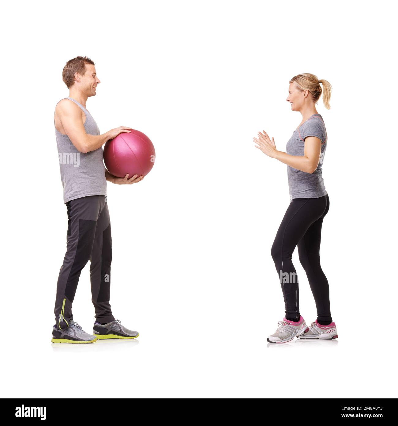 Getting fit and having fun. A man and woman exercising by throwing a ...