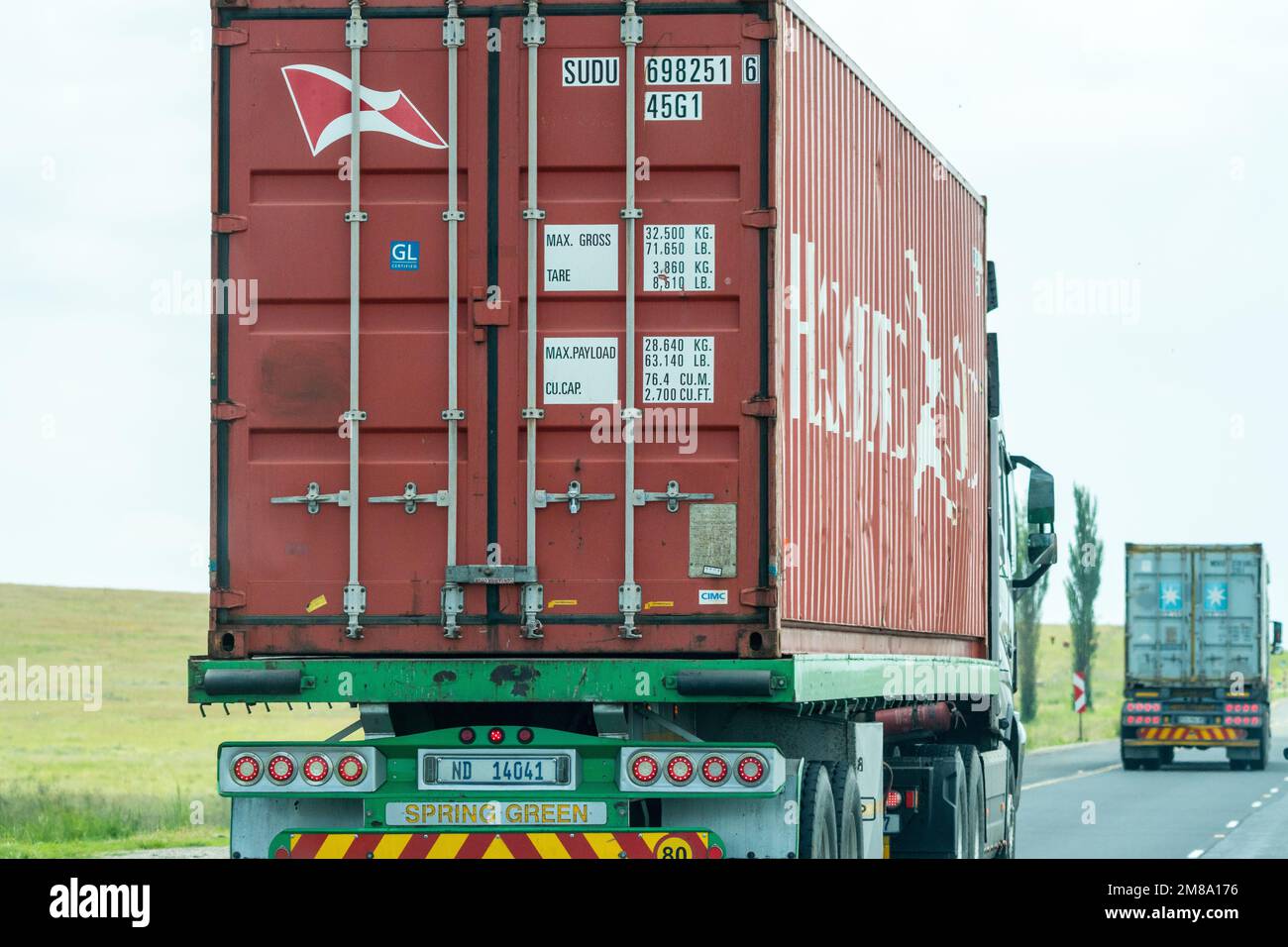 shipping containers on trucks or lorries being transported as freight ...