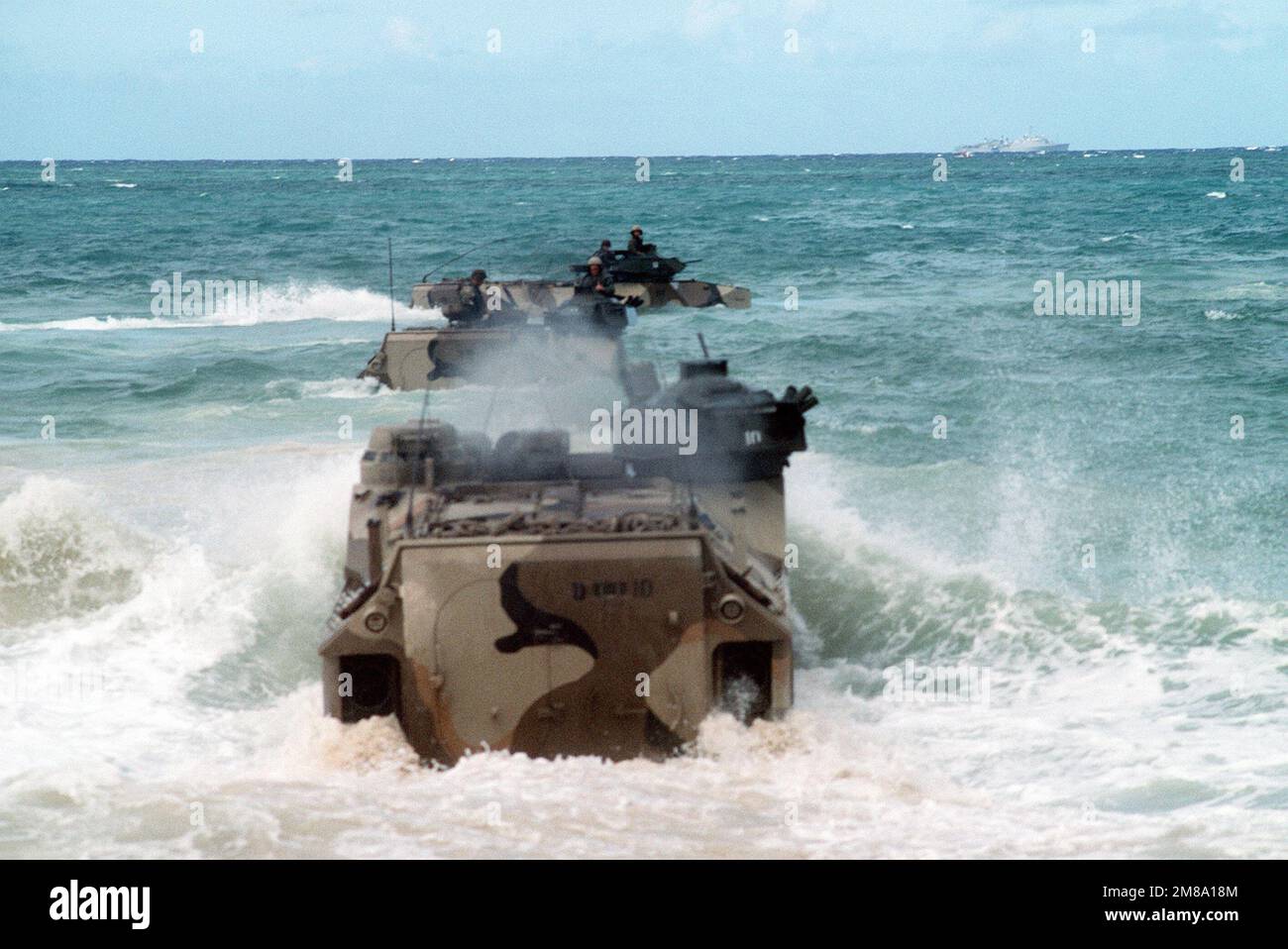 Three AAVP-7 Assault Amphibian Vehicles (AAVs) enter the surf as they ...