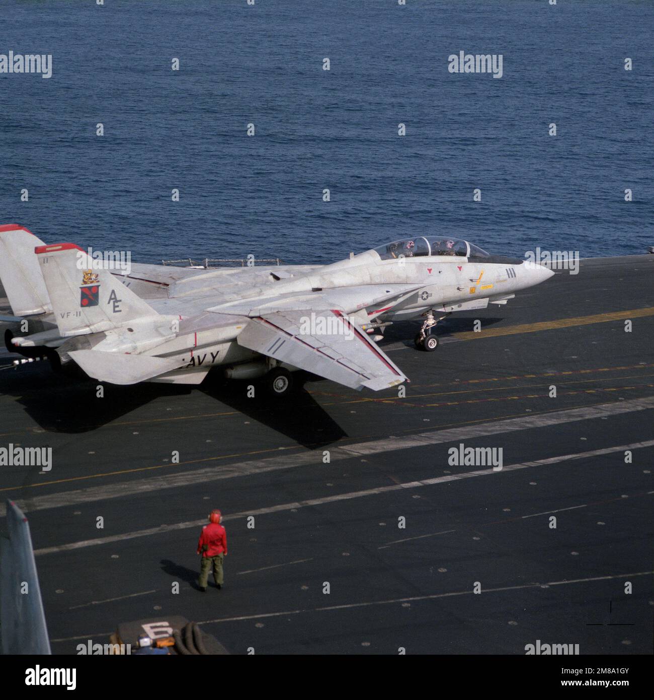 A fighter Squadron II (VF-11) F-14A Tomcat aircraft comes to a stop after landing on the ...