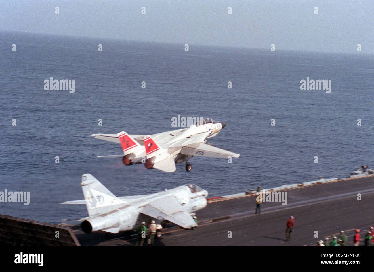 A Fighter Squadron 31 (VF-31) F-14A Tomcat aircraft climbs skyward ...