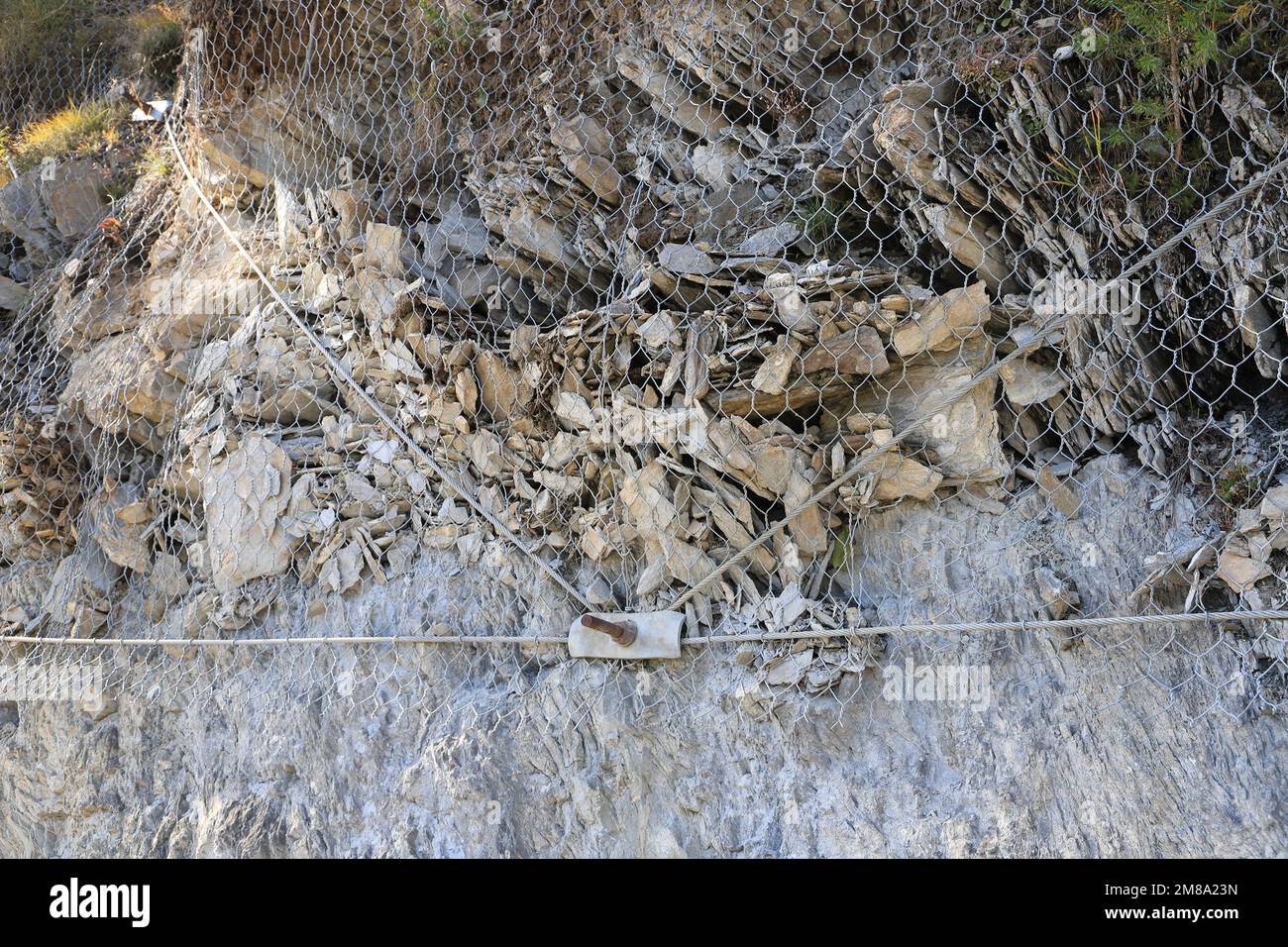 a steel net as security against falling rocks Stock Photo - Alamy