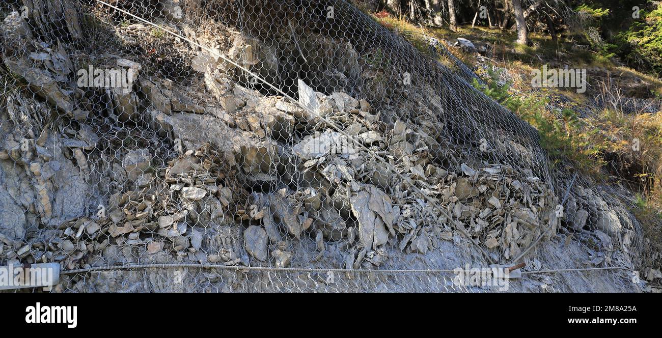 a steel net as security against falling rocks Stock Photo - Alamy